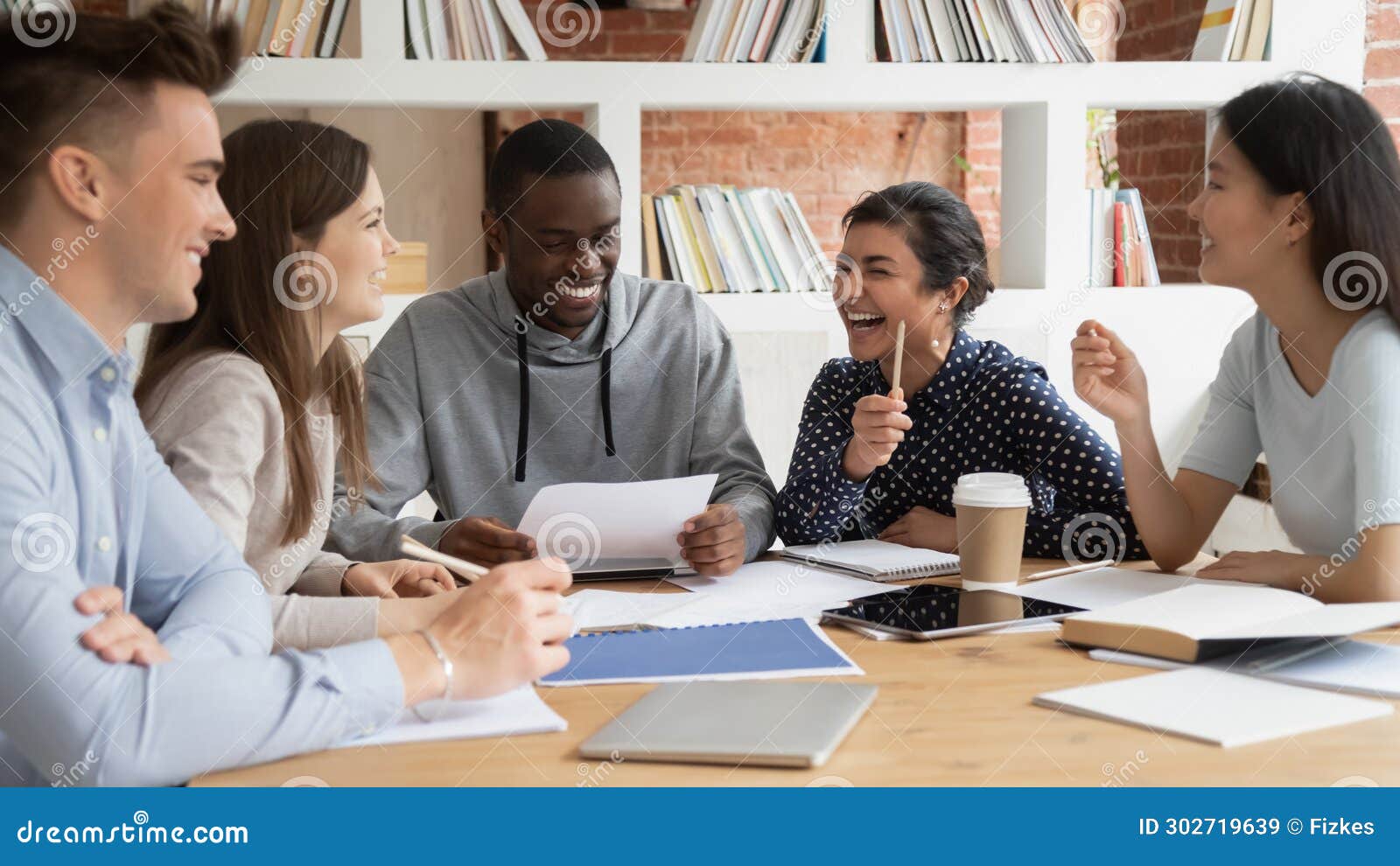 Overjoyed Multiethnic Students Laugh Studying Together in Class Stock ...