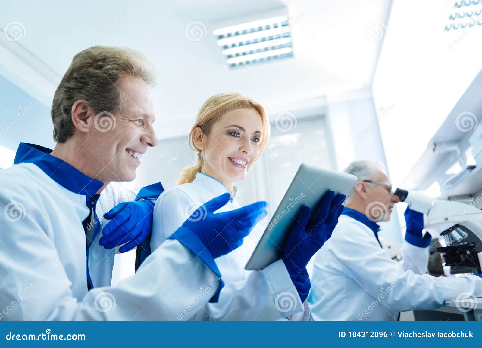 Overjoyed Smiling Scientists Looking at the Tablet Stock Photo - Image ...