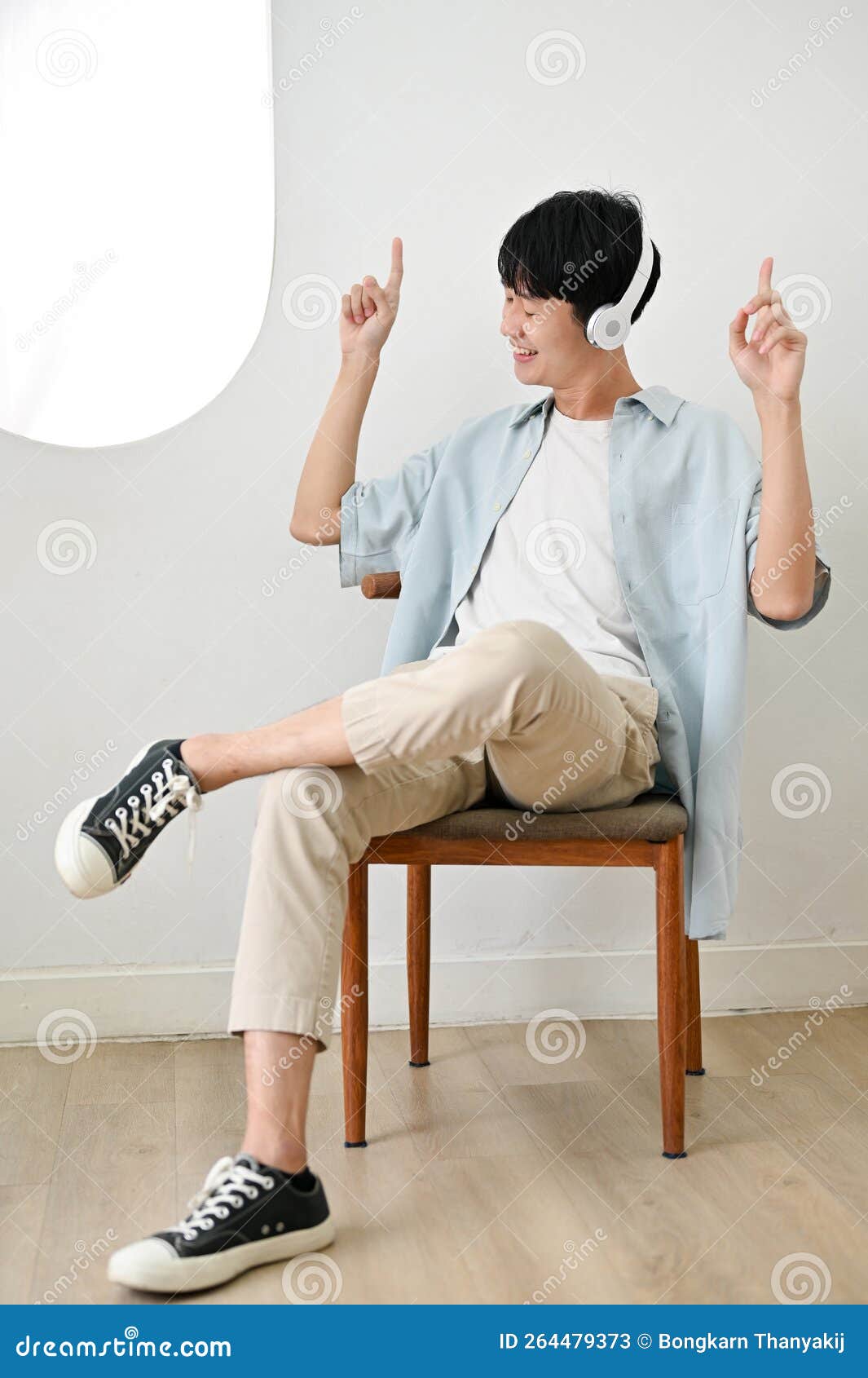 Overjoyed Young Asian Man Enjoying with the Music, Listening To Music ... Overjoyed Young Asian Man Enjoying with the Music, Listening To Music ...