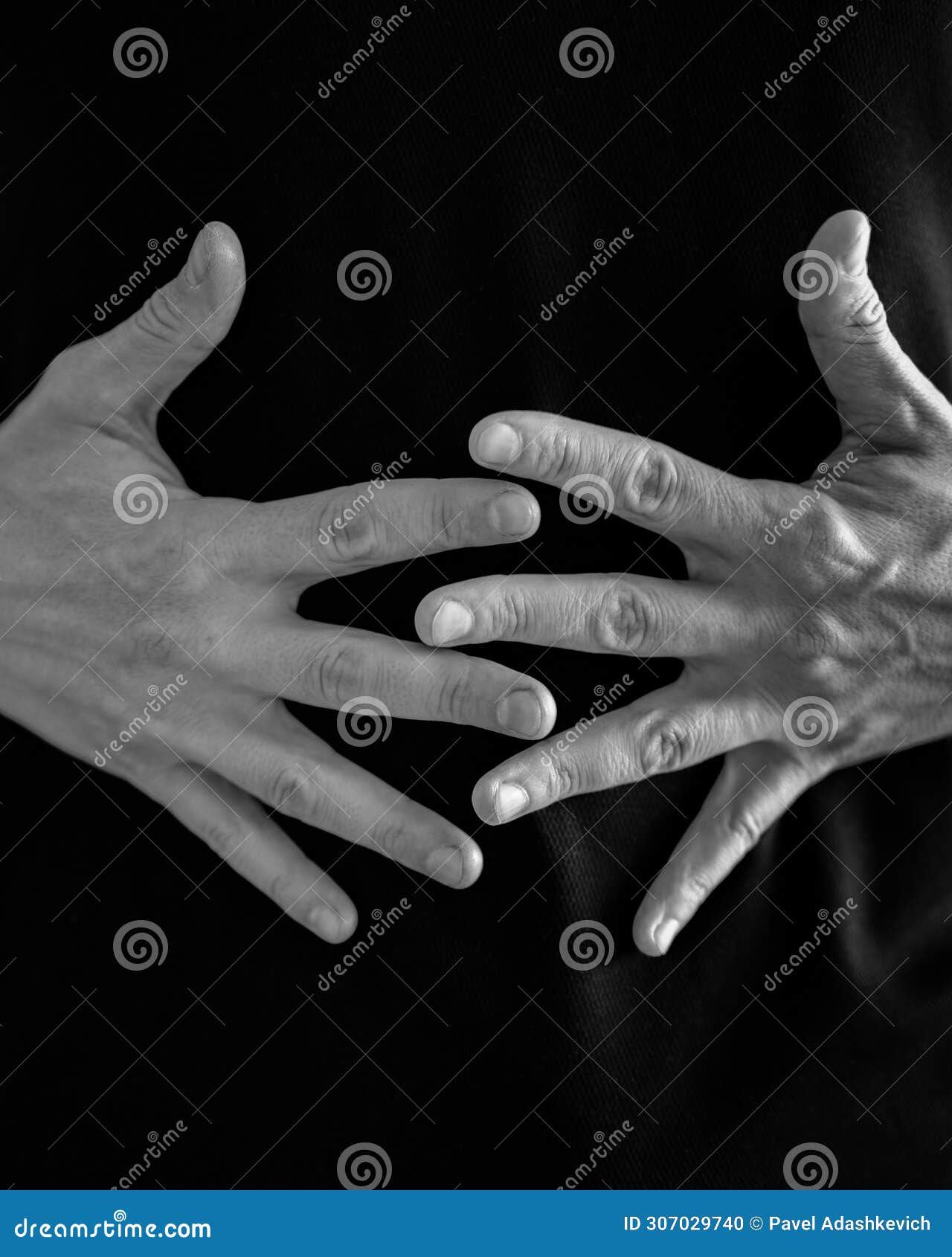 Hands Intertwined in a Gesture of Complexity on a Dark Background Stock ...