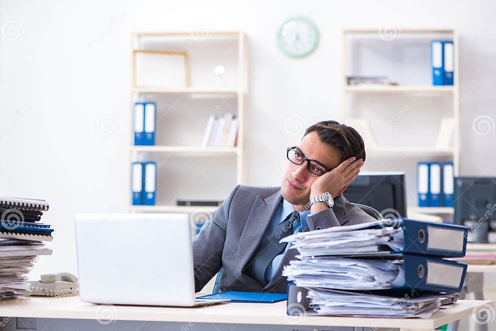 The Overloaded with Work Employee Under Paperwork Burden Stock Photo ...