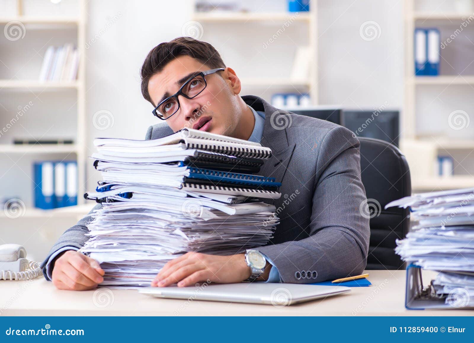 The Overloaded with Work Employee Under Paperwork Burden Stock Photo ...