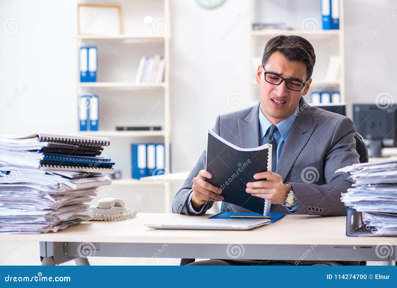 The Overloaded with Work Employee Under Paperwork Burden Stock Photo ...