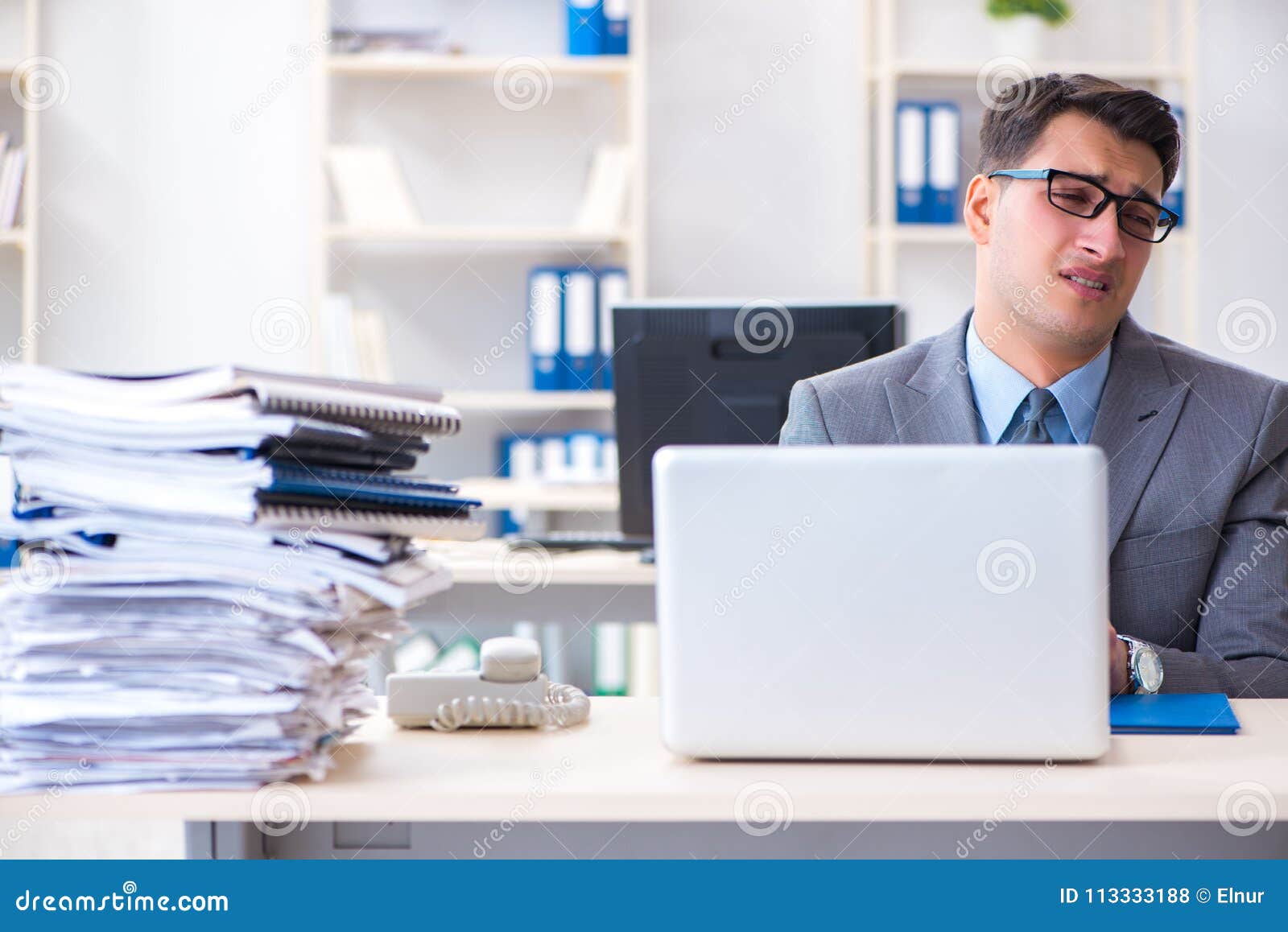 The Overloaded with Work Employee Under Paperwork Burden Stock Photo ...