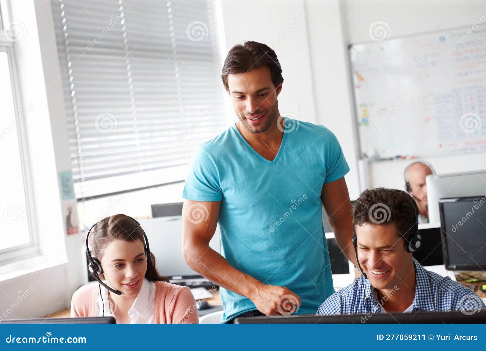 Overseeing the Task at Hand. a Handsome Young Man Overseeing the Work ...