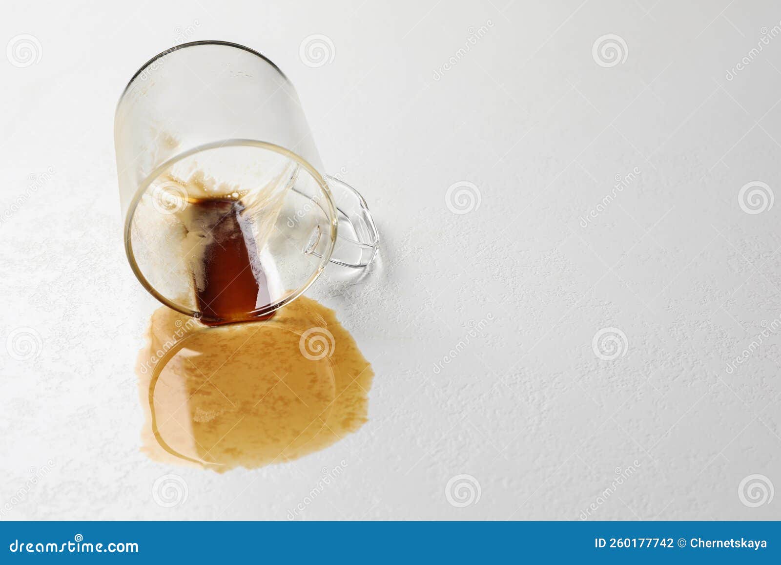 Overturned Cup and Spilled Coffee on Light Table. Space for Text Stock ...