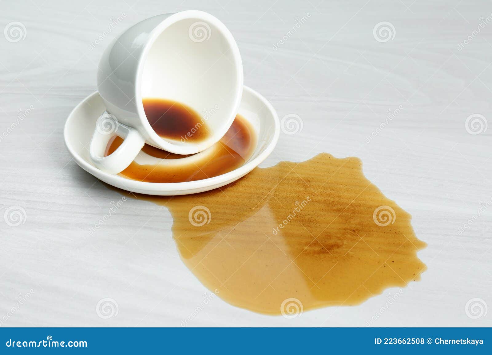 Overturned Cup and Spilled Coffee on White Wooden Table Stock Photo ...