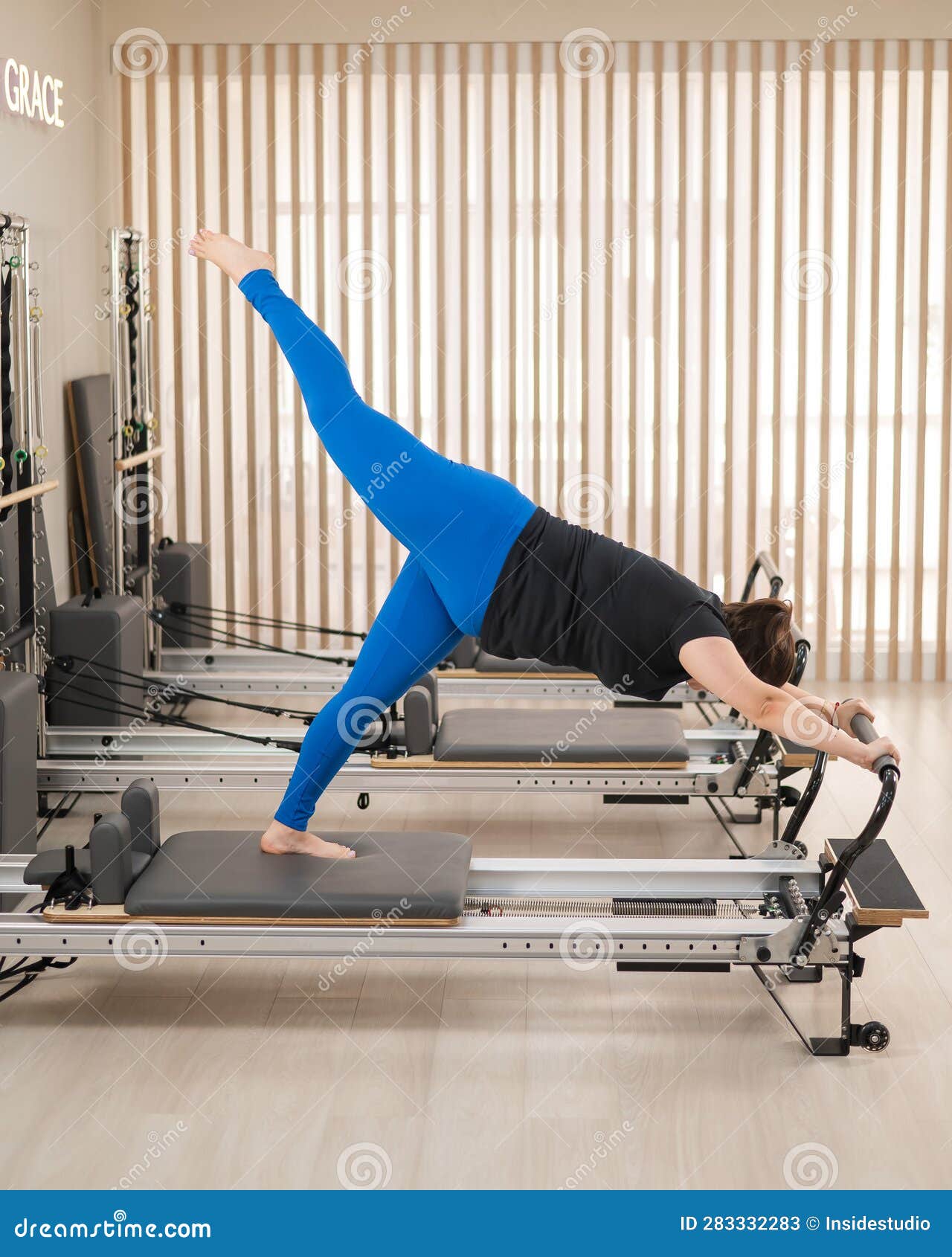 Overweight Caucasian Woman Doing Pilates Exercises on a Reformer. Stock ... Overweight Caucasian Woman Doing Pilates Exercises on a Reformer. Stock ...