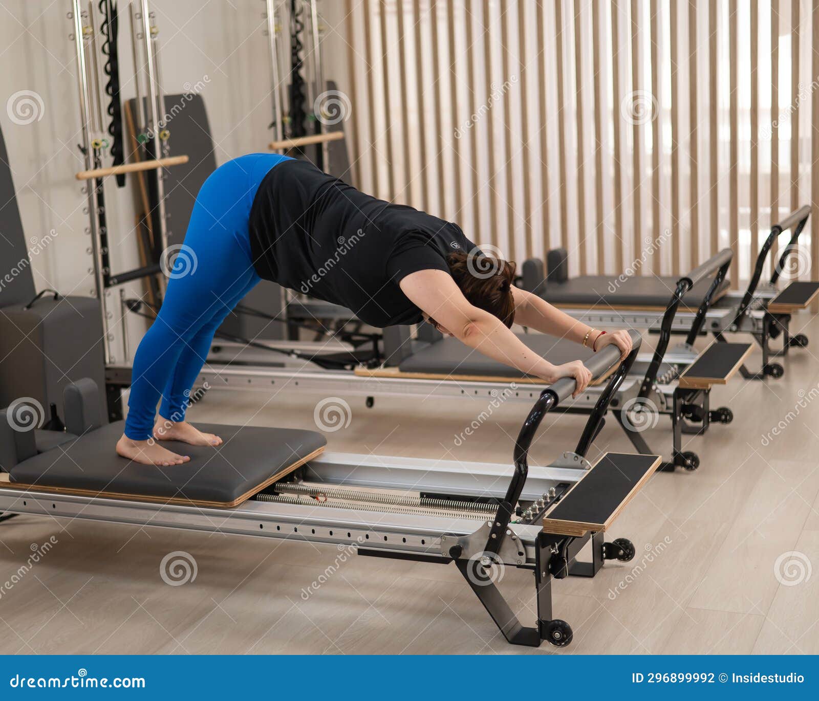 Overweight Caucasian Woman Doing Pilates Exercises on a Reformer. Stock ... Overweight Caucasian Woman Doing Pilates Exercises on a Reformer. Stock ...