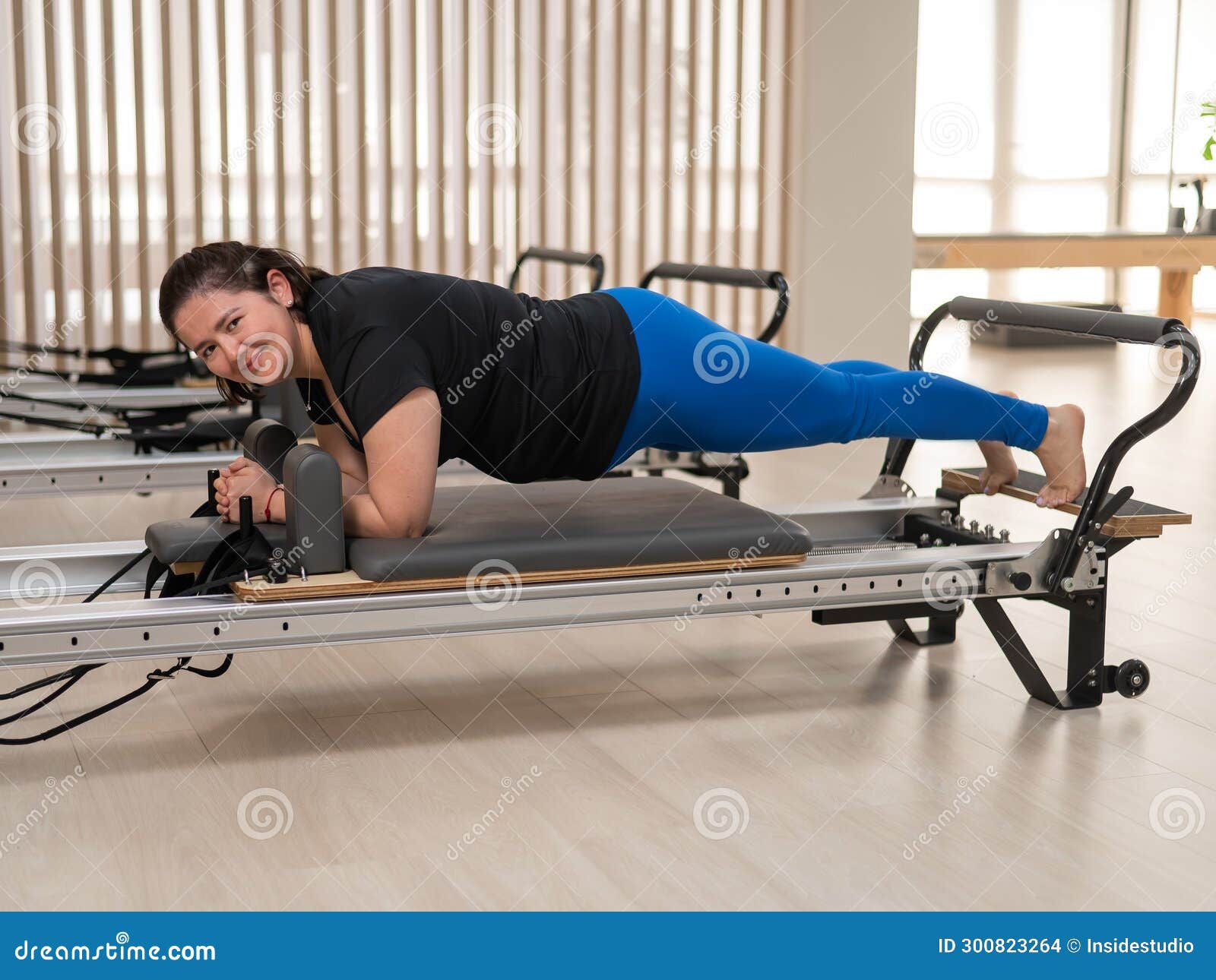Overweight Caucasian Woman Doing Pilates Exercises on a Reformer. Stock ... Overweight Caucasian Woman Doing Pilates Exercises on a Reformer. Stock ...
