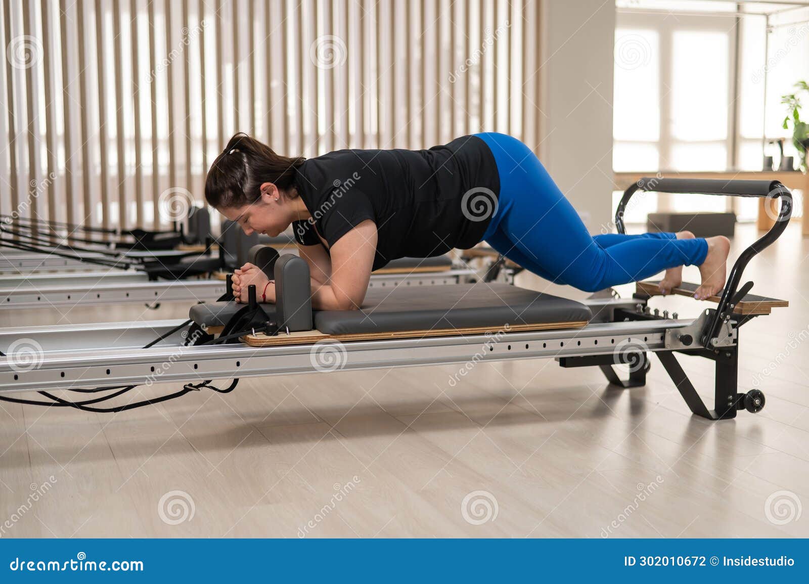 Overweight Caucasian Woman Doing Pilates Exercises on a Reformer. Stock ... Overweight Caucasian Woman Doing Pilates Exercises on a Reformer. Stock ...