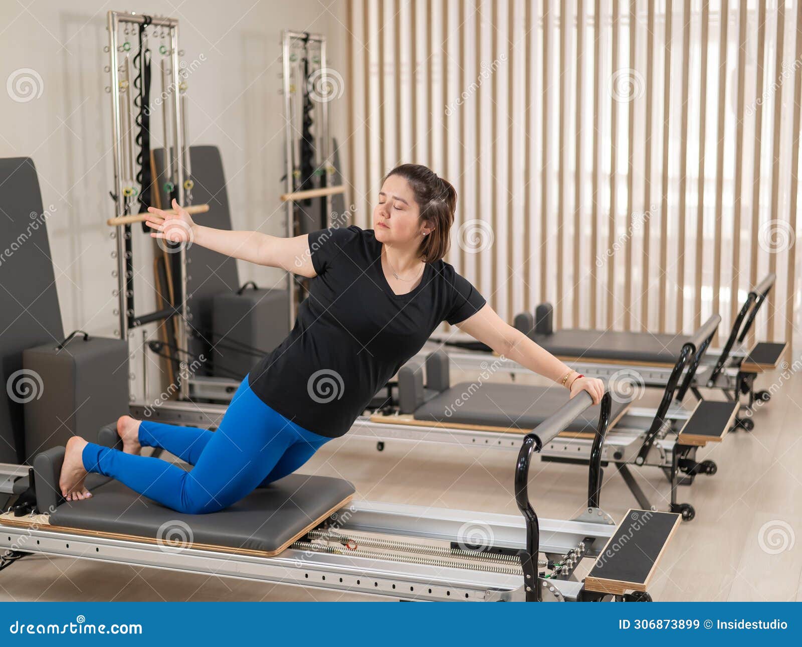 Overweight Caucasian Woman Doing Pilates Exercises on a Reformer. Stock ... Overweight Caucasian Woman Doing Pilates Exercises on a Reformer. Stock ...