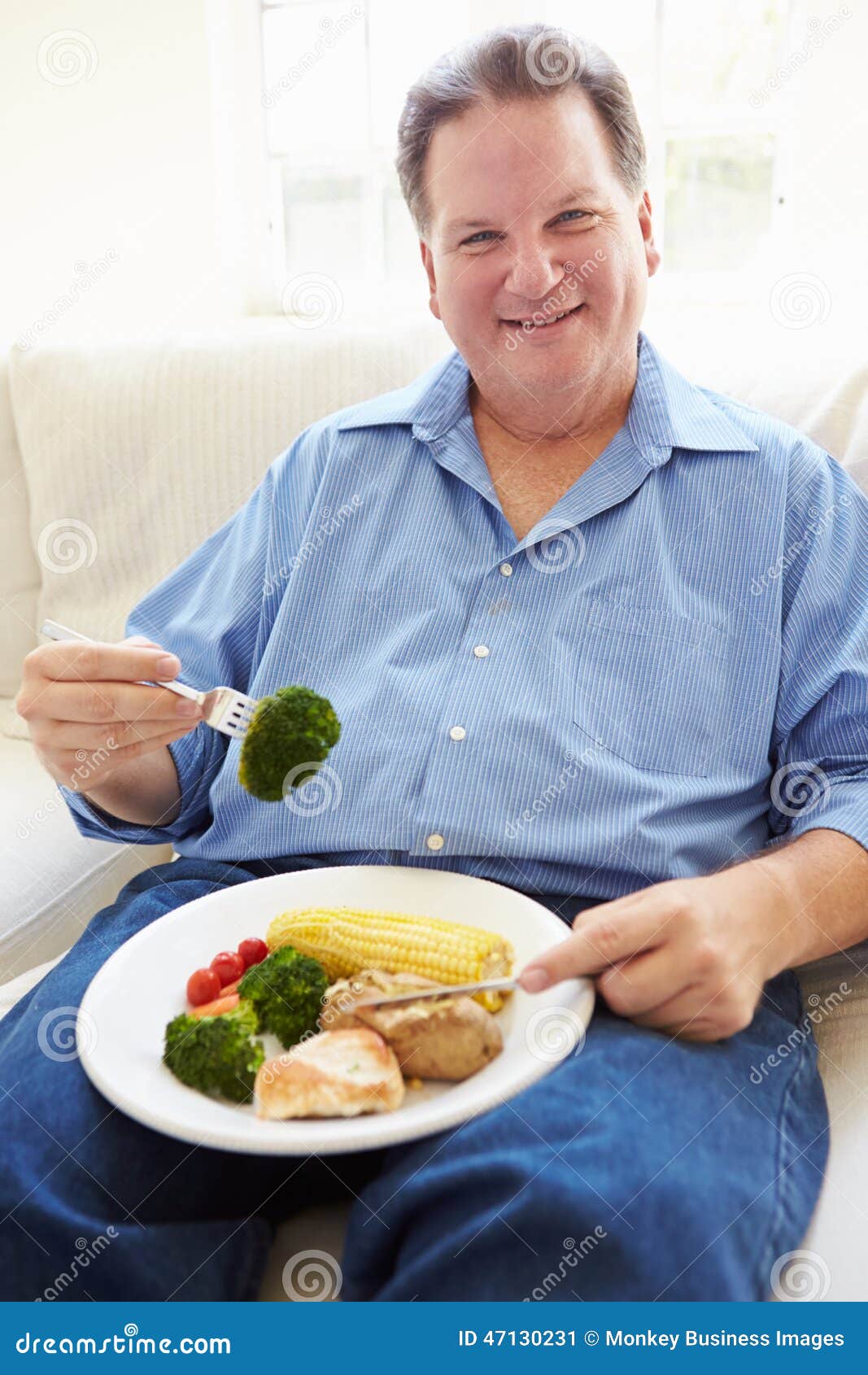 Overweight Man Eating Healthy Meal Sitting on Sofa Stock Image - Image ...