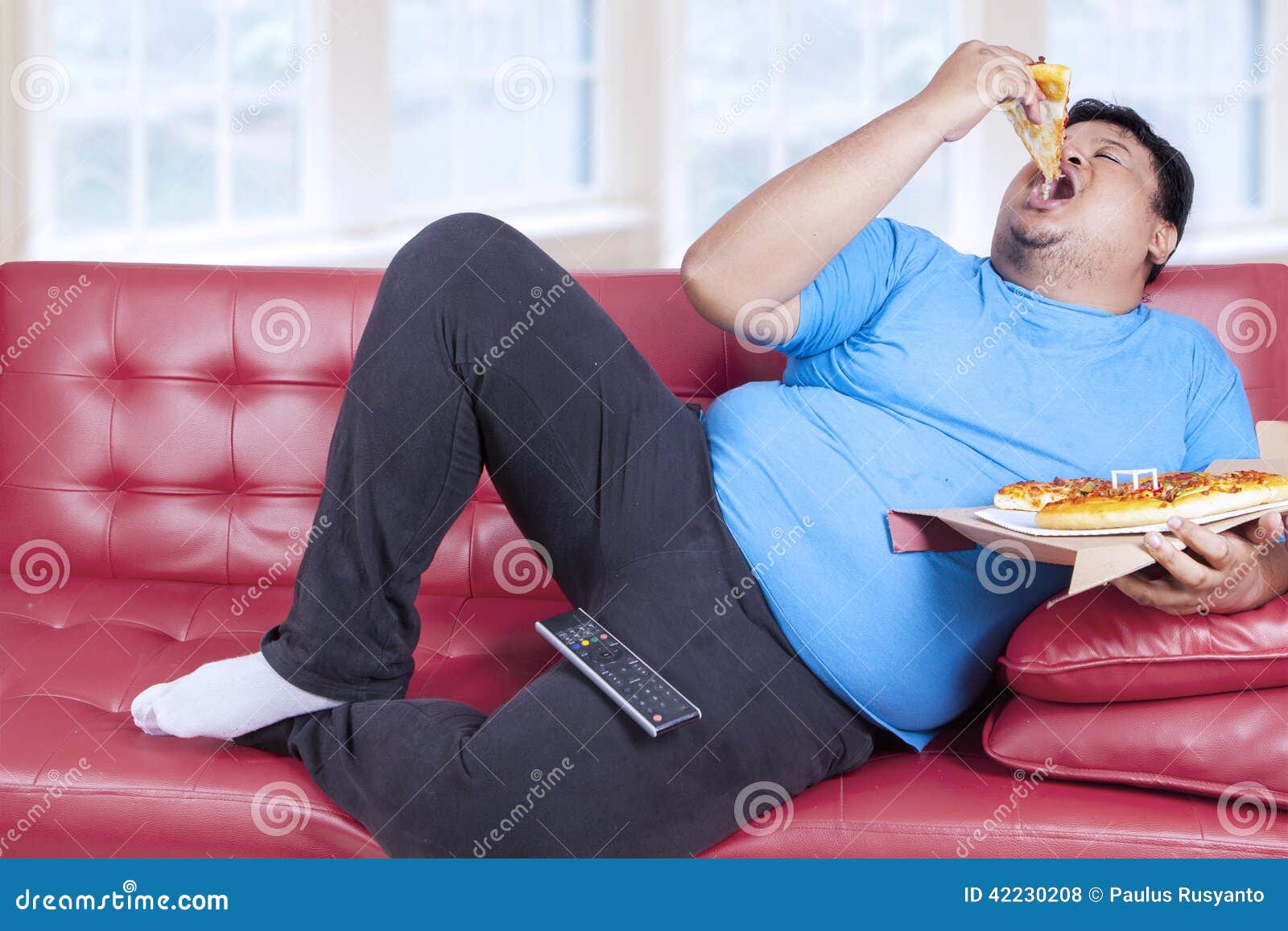 Overweight man eats pizza stock photo. Image of large - 42230208