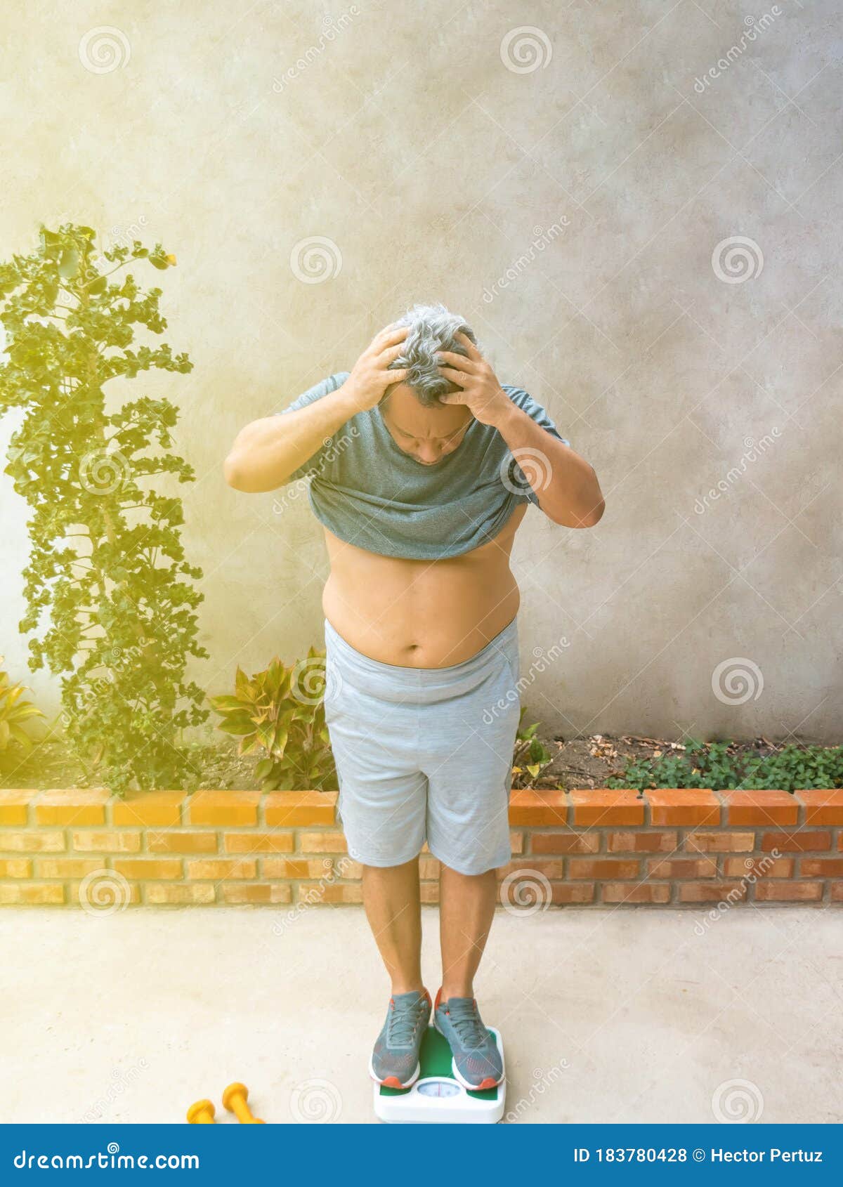 Overweight Man Who Weighs Himself on a Scale at Home Stock Photo ...