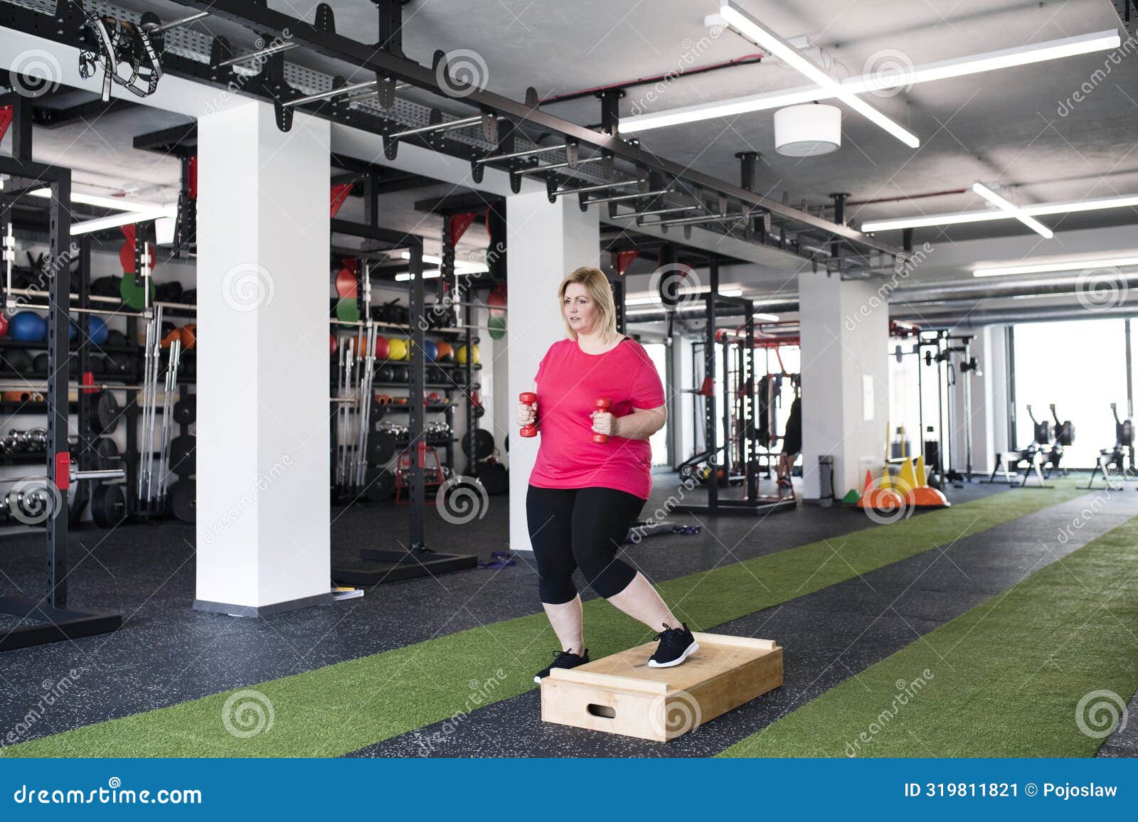 Overweight Woman Exercising in Gym, Using Dumbbells. Stock Image ...