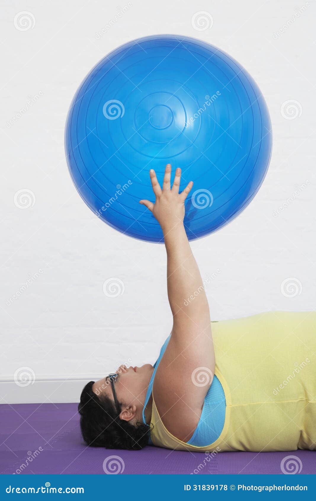 Overweight Woman Holding Up Exercise Ball Stock Photo - Image of people ...