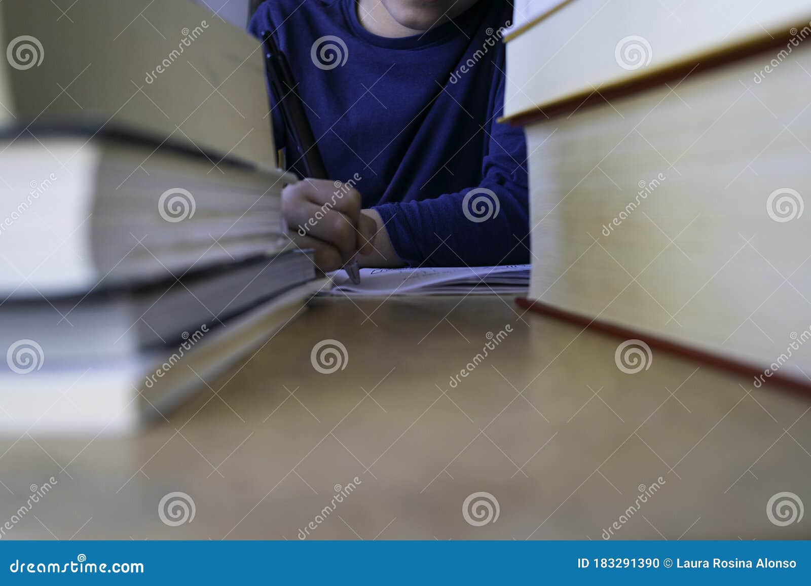 Overwhelmed Boy Does Homework among Mountains of Books Stock Photo ...