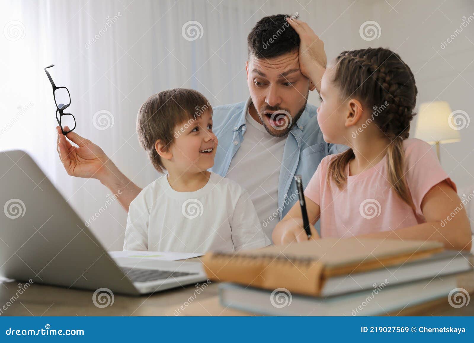 Overwhelmed Man Combining Parenting and Work at Home Stock Image ...