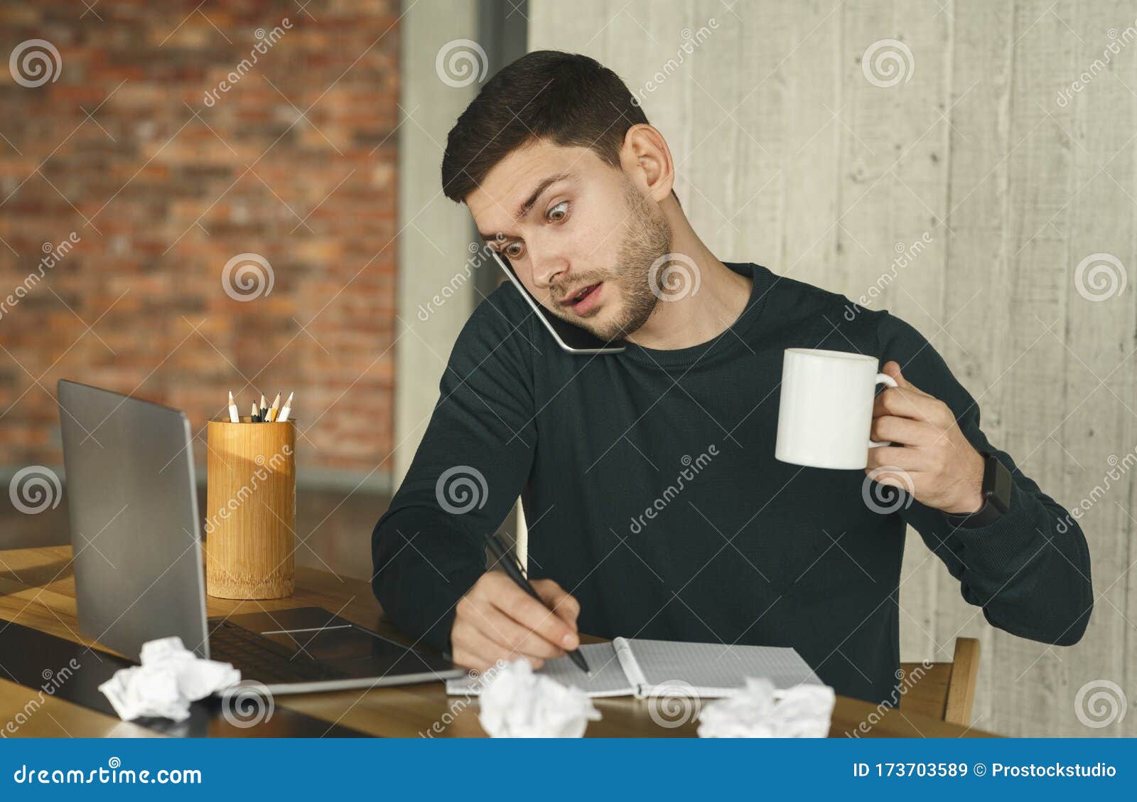 Overwhelmed Man Multitasking Talking on Phone Sitting in Office Stock ...