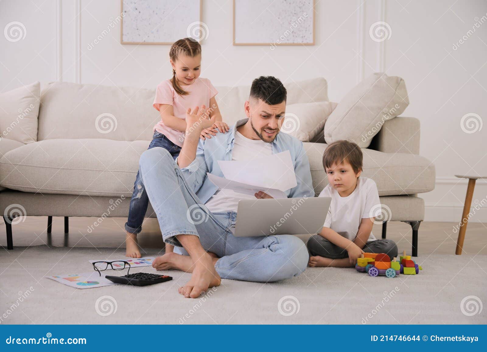 Overwhelmed Man Combining Parenting and Work at Home Stock Photo ...