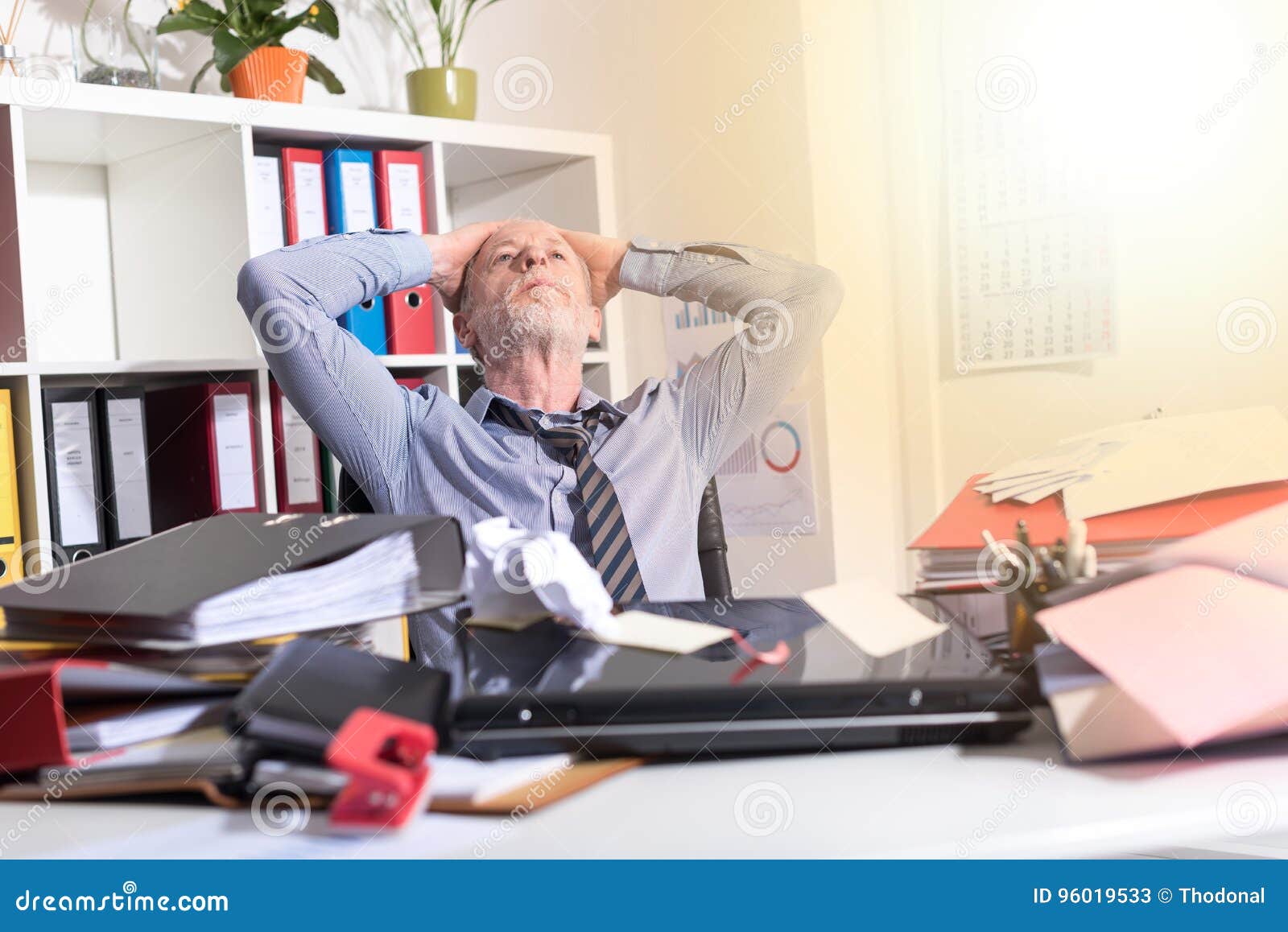 Overworked Businessman Sitting at a Messy Desk, Light Effect Stock ...