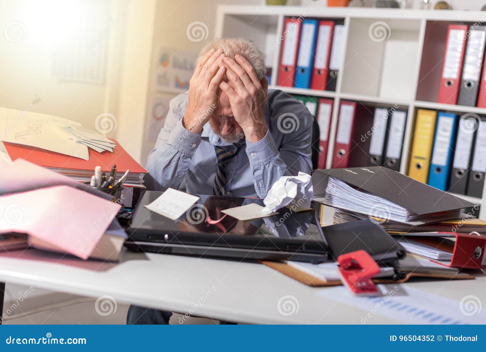 Overworked Businessman Sitting at a Messy Desk, Light Effect Stock ...