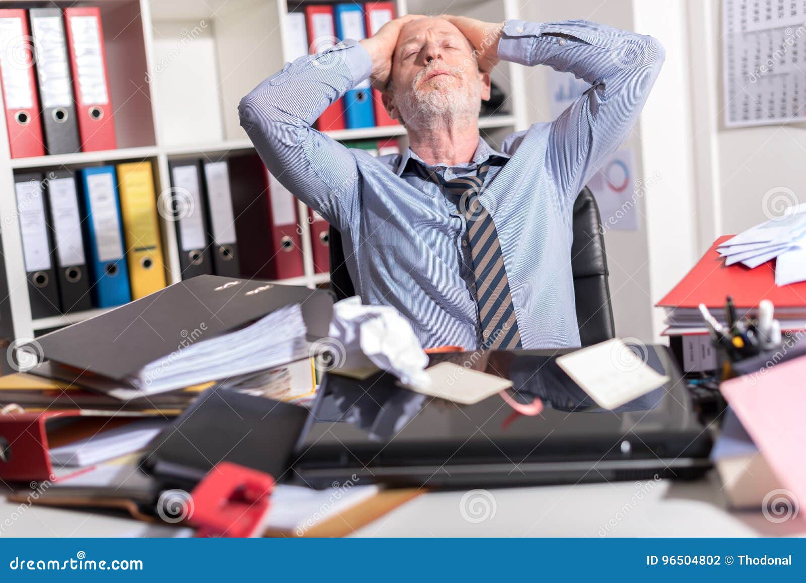 Overworked Businessman Sitting at a Messy Desk Stock Photo - Image of ...