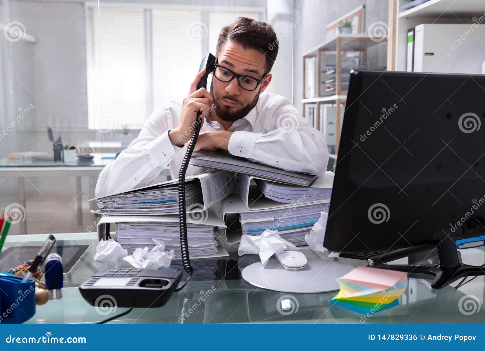 Overworked Businessman Talking on Landline Stock Photo - Image of ...
