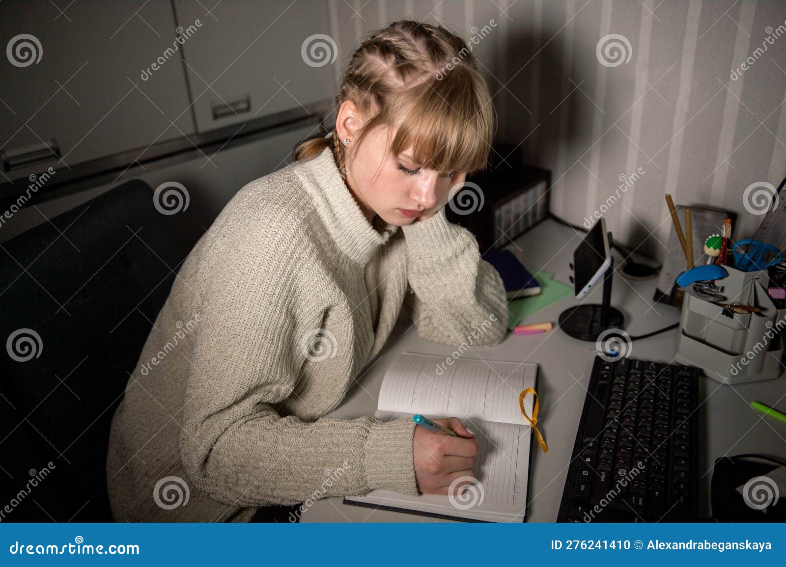 An Overworked Student Sits at the Computer at Night. Make Notes in a ...
