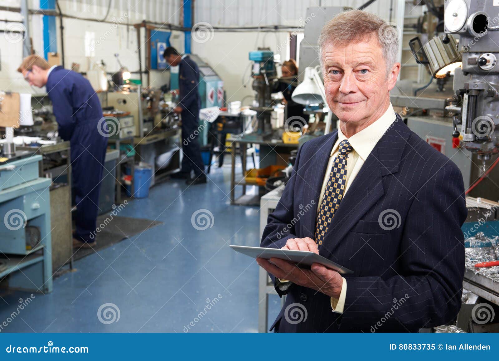 Owner of Engineering Factory with Staff in Background Stock Image ...