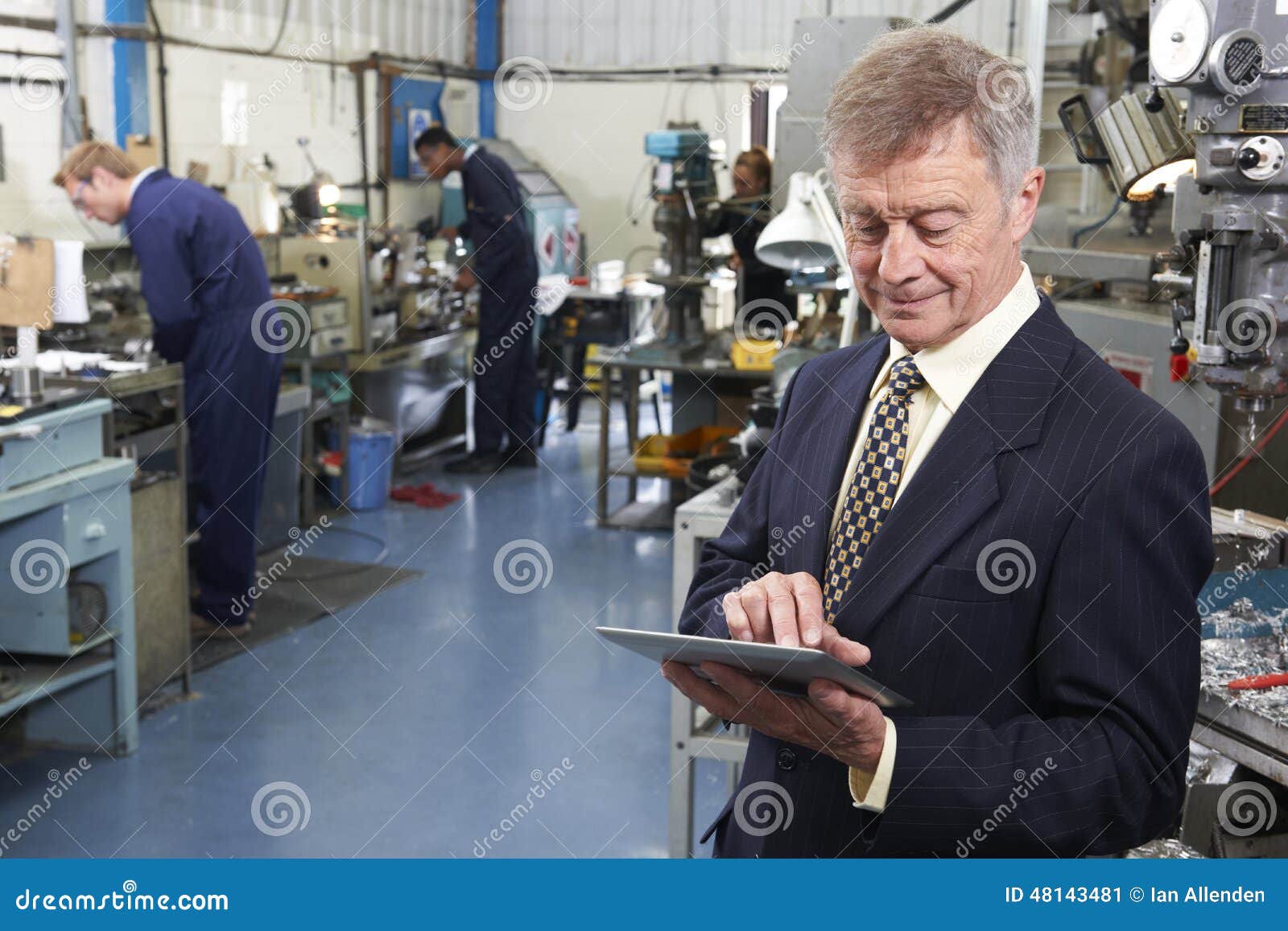 Owner of Engineering Factory Using Digital Tablet with Staff in Stock ...