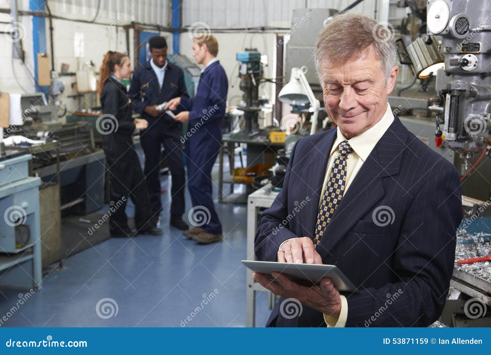 Owner of Engineering Factory Using Digital Tablet with Staff in Stock ...
