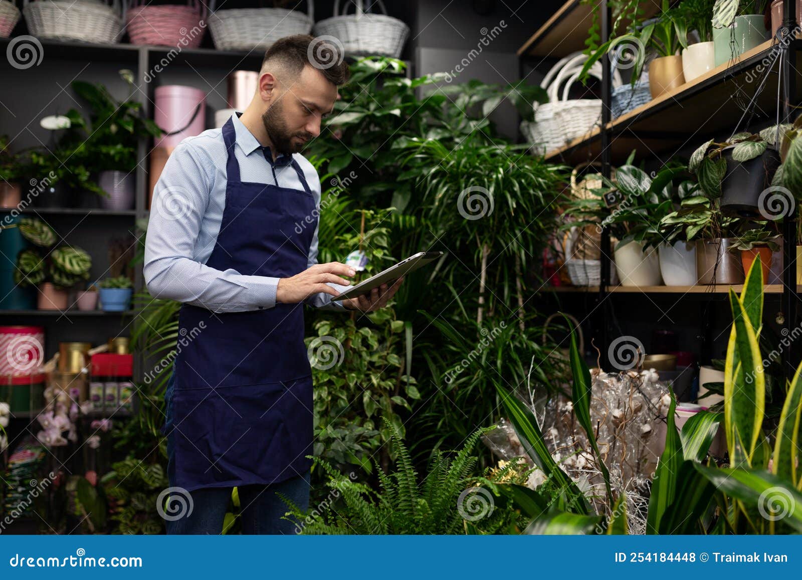 The Owner of a Potted Plant Shop Doing Inventory Stock Photo - Image of ...