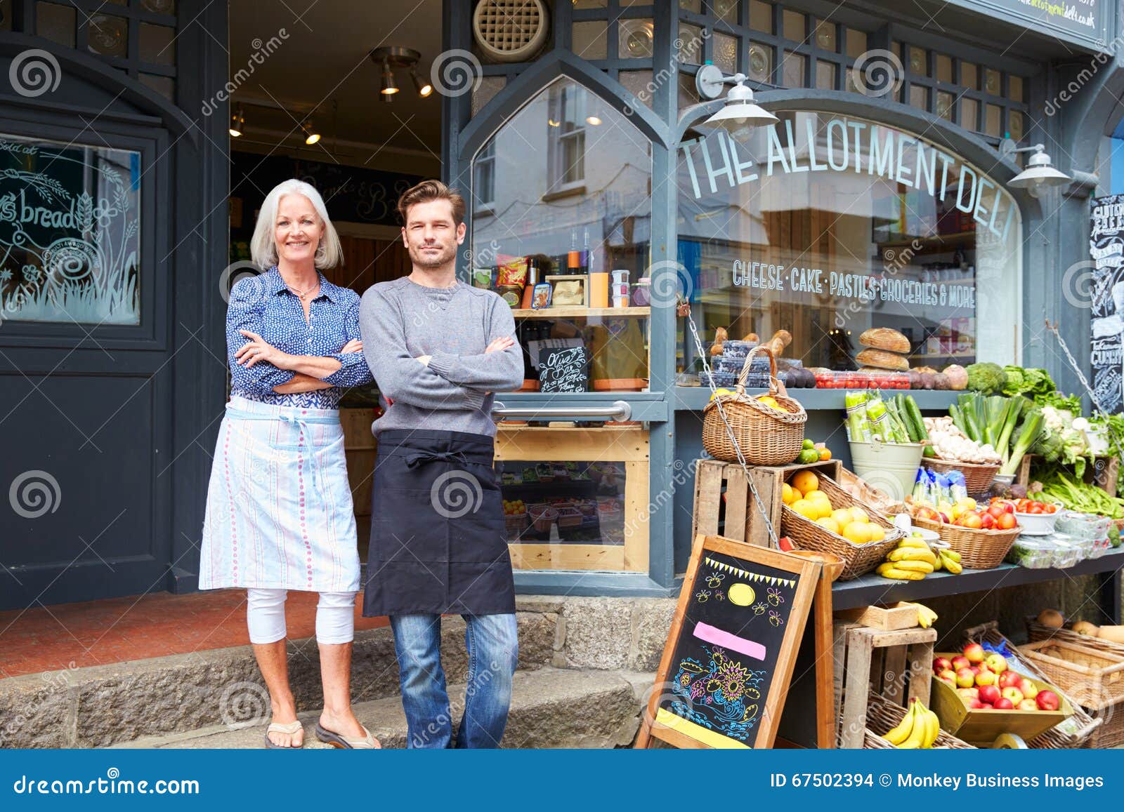 Owners Standing Next To Produce Display at Deli Editorial Stock Image ...