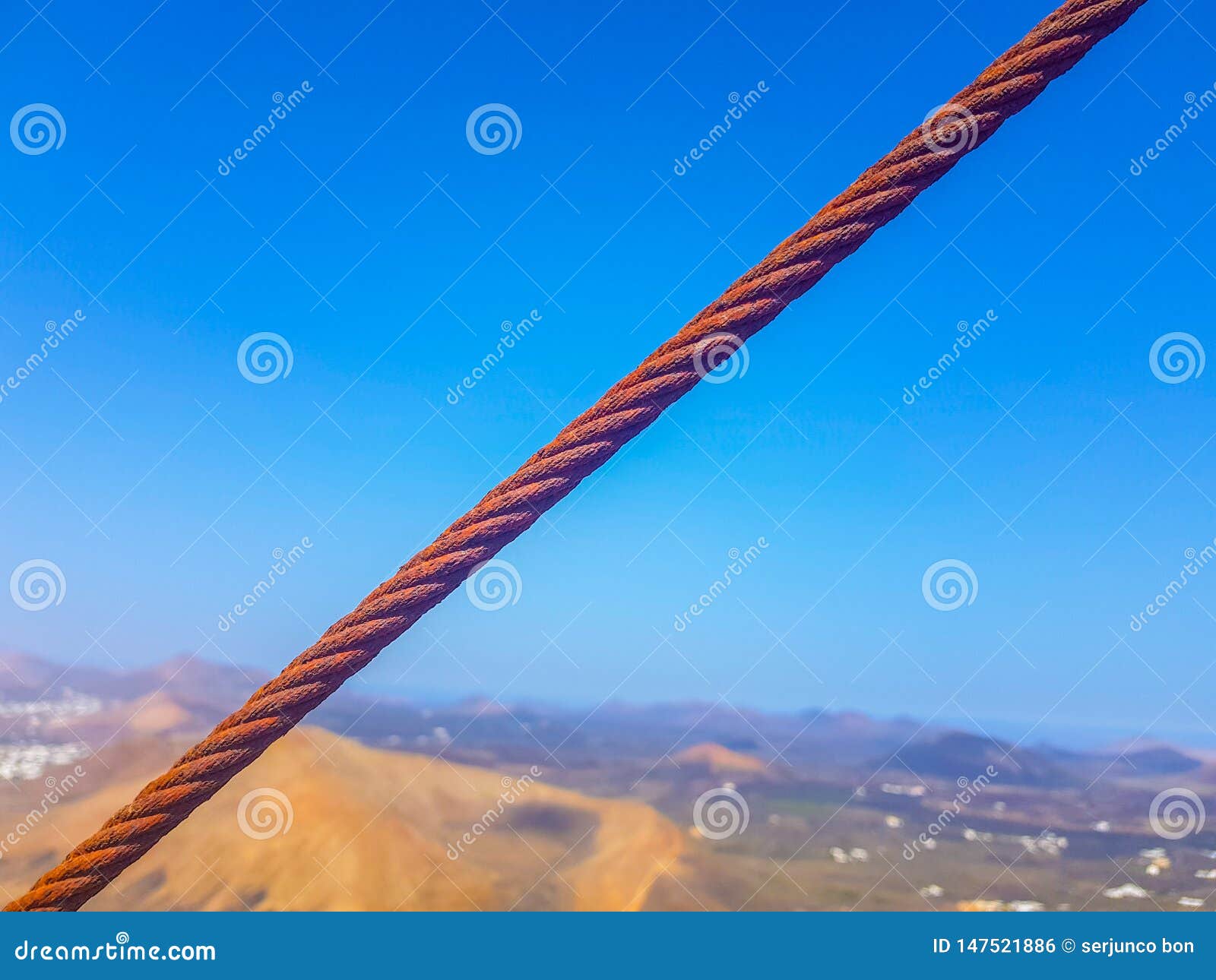 Oxidized Interlocked Wire Loop Cables in the Foreground with Sky and ...