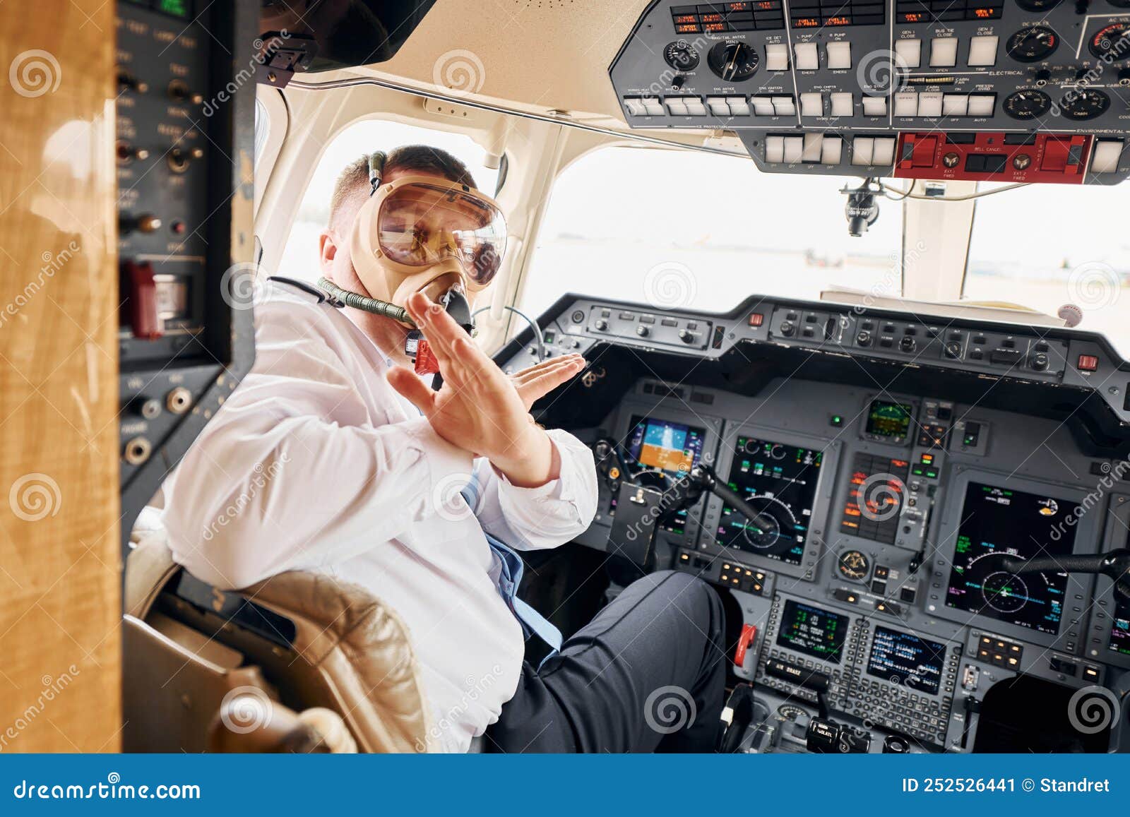 In Oxygen Mask. Pilot in Formal Wear Sits in the Cockpit and Controls ...