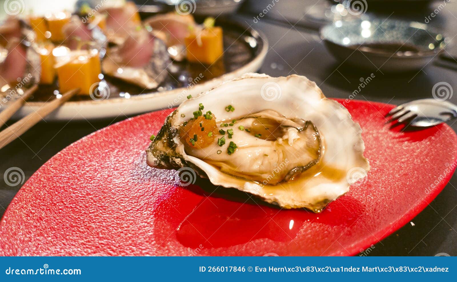Oyster Seasoned on Red Plate in a Restaurant Stock Photo - Image of ...