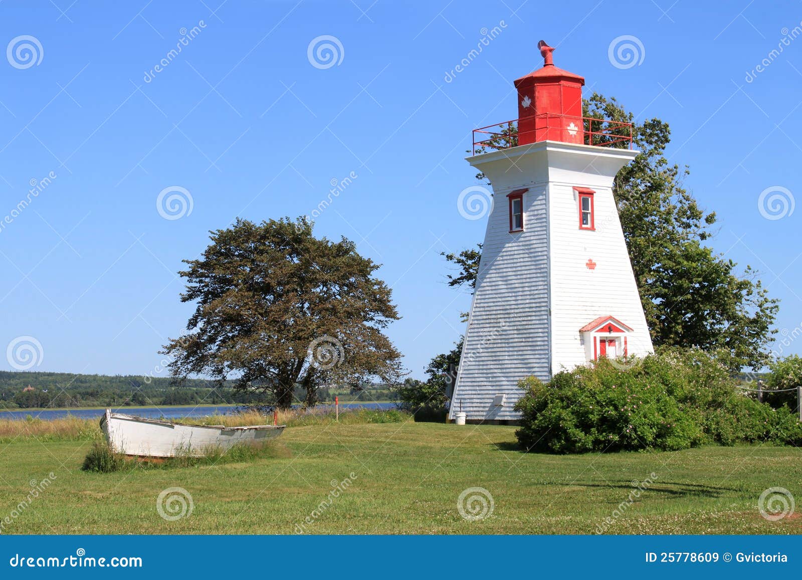 P.E.I. lighthouse and boat stock image. Image of travel - 25778609