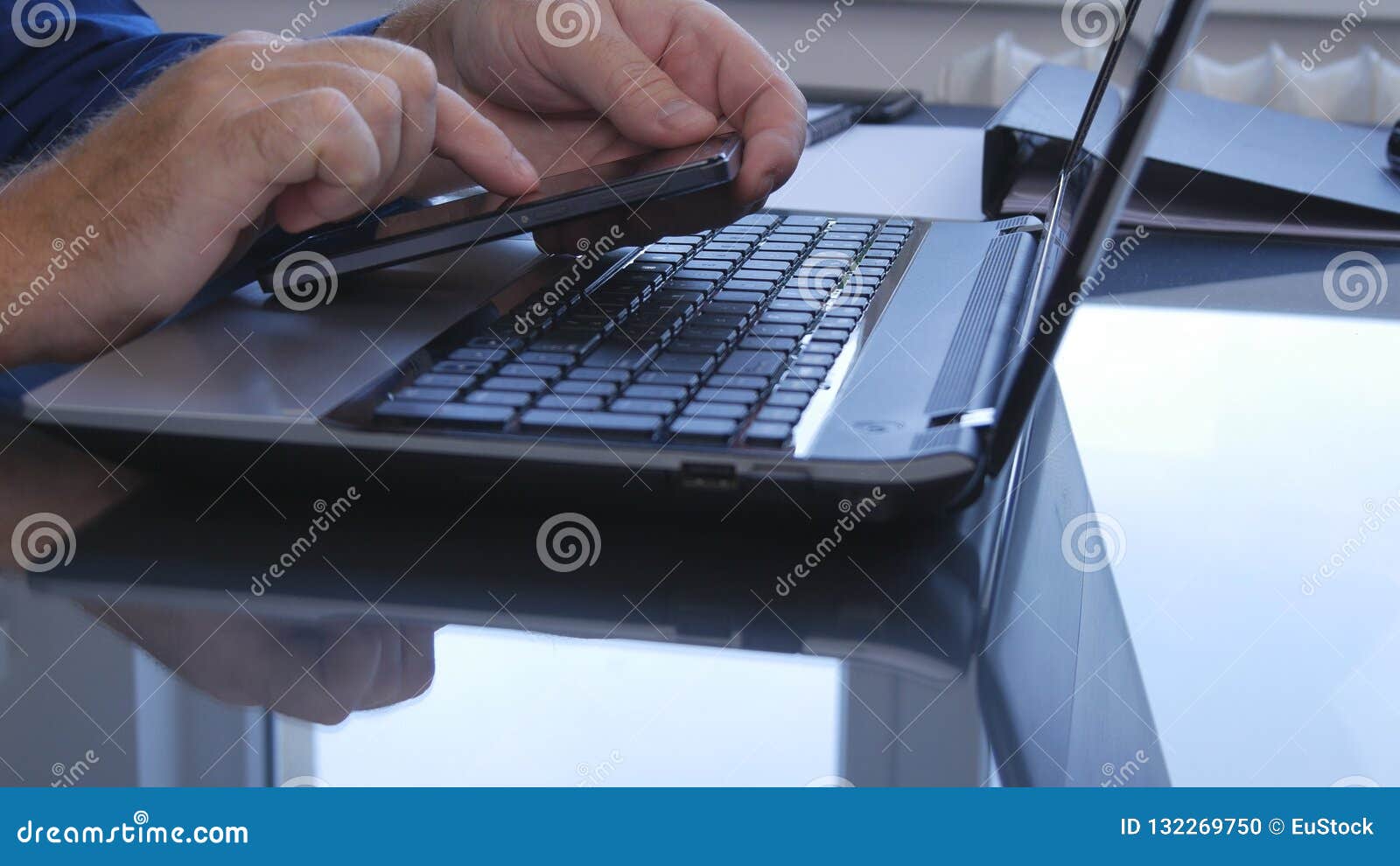 Businessperson Working in Office Using Smartphone and Laptop Wireless ...