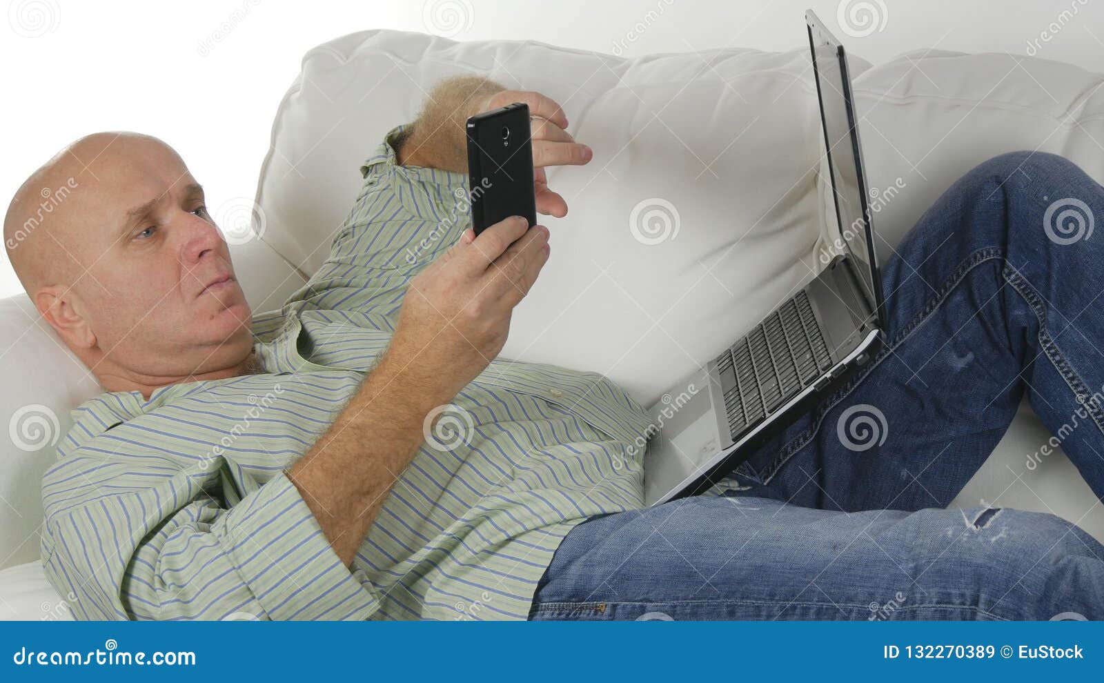 Relaxed Man Resting in the Couch Text Using Smartphone Stock Image ...