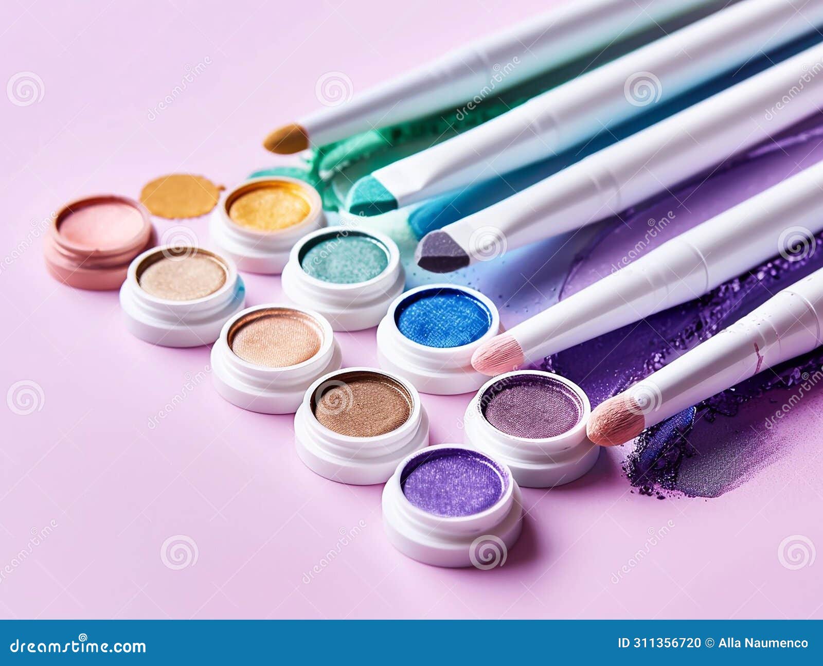 Pack Of Eyeshadows Of Various Colors With Sponge Next To A Light Purple ...