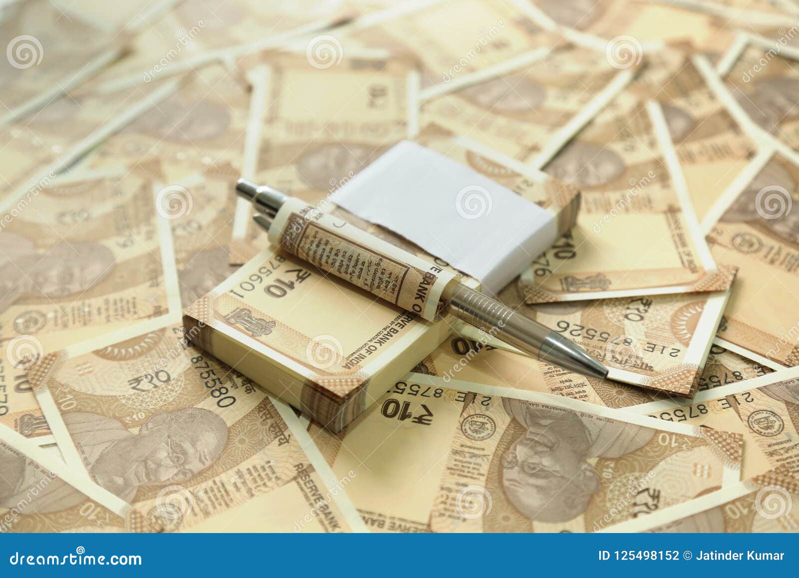 Pack of Indian 10 Rupee Currency Note with Pen and Scattered Indian ...