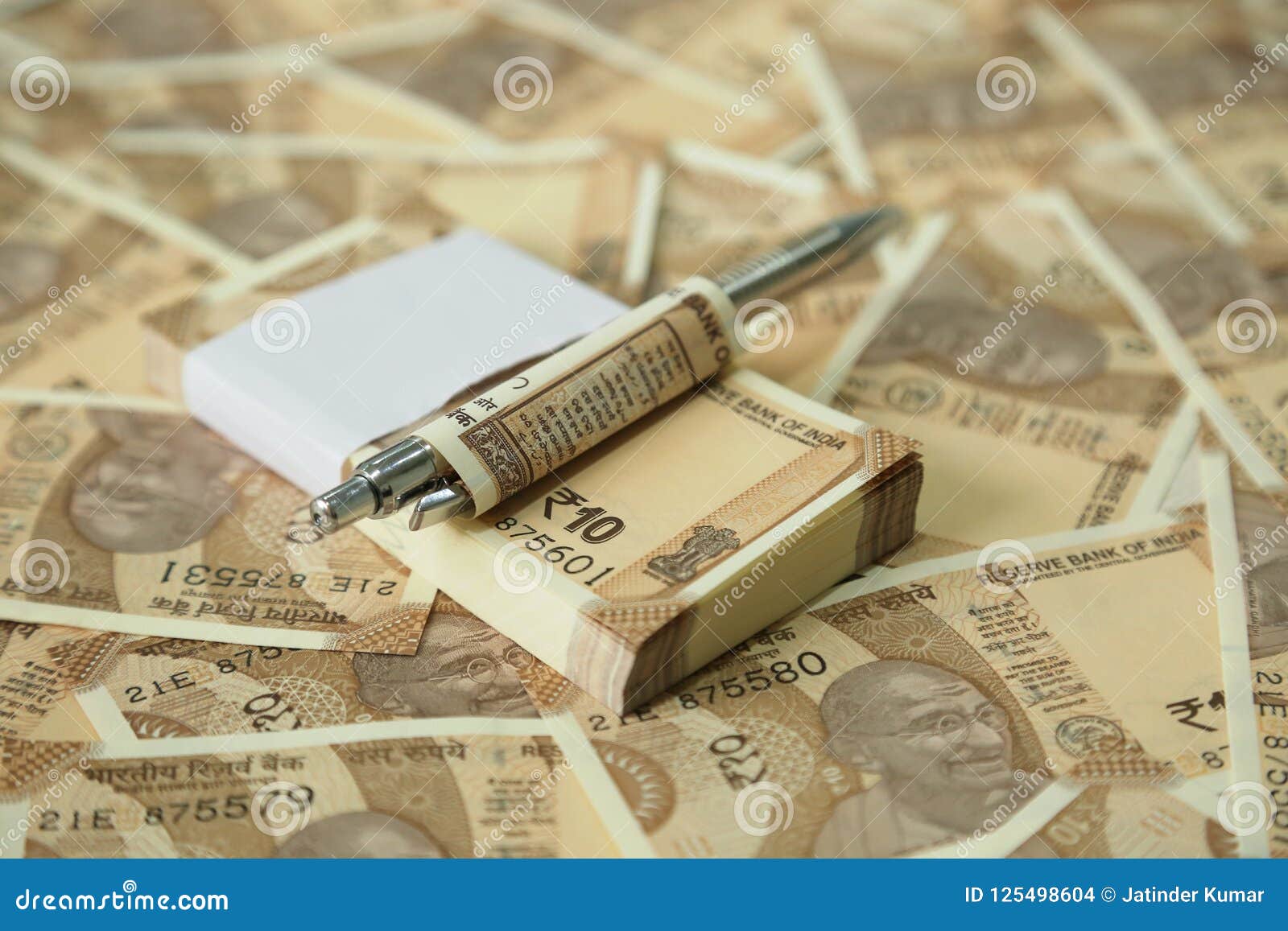 Pack of Indian 10 Rupee Currency Note with Pen and Scattered Indian ...