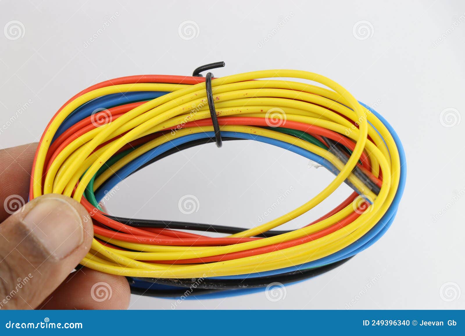 Pack of Multicolored Wire Tied with a Small Piece of Cable Held in Hand ...