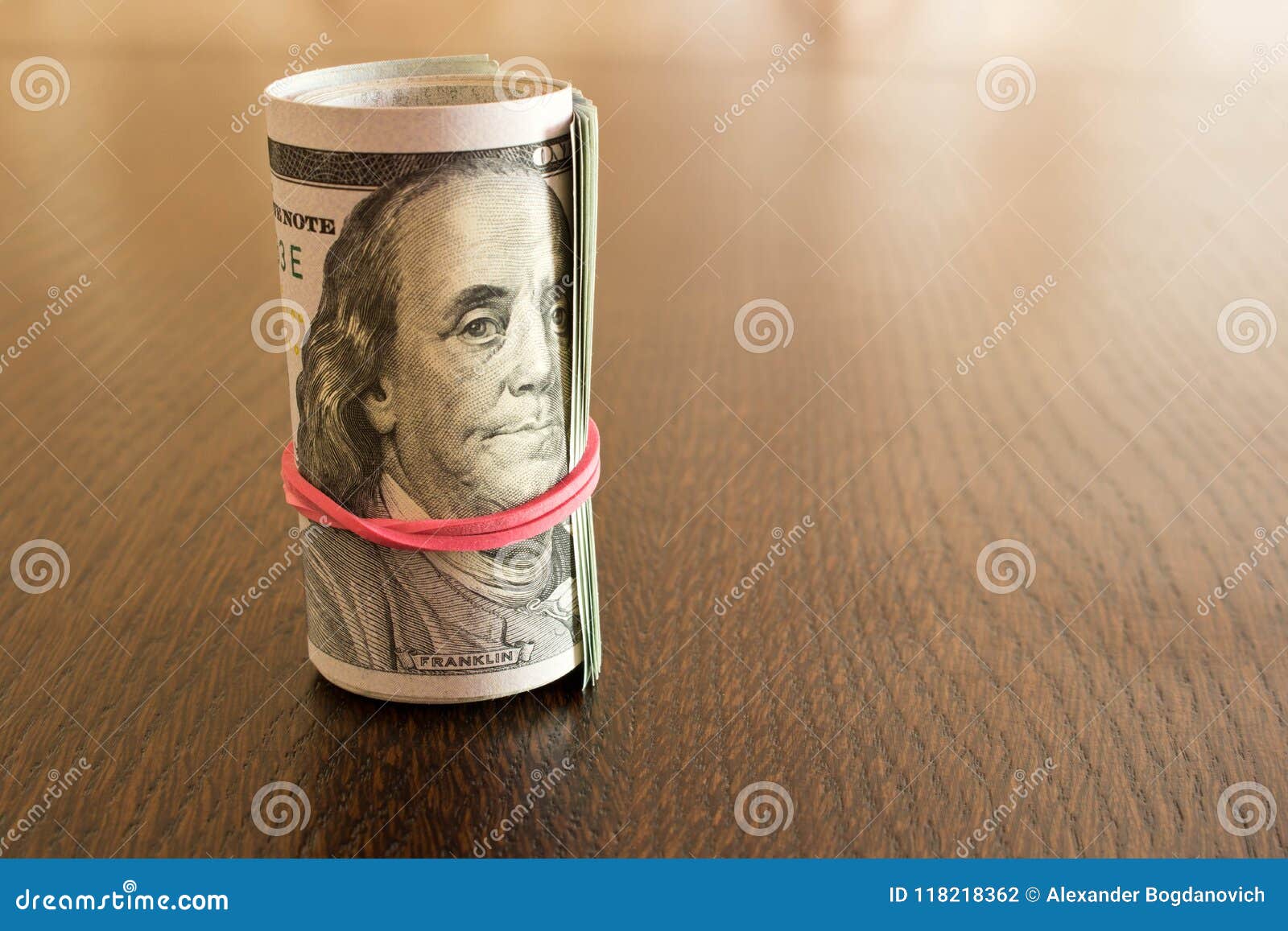 A Pack of Twisted 100 Dollar Bills . on a Wooden Table Stock Photo ...