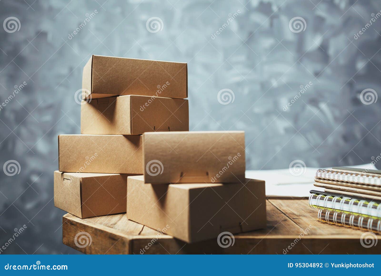 Package Box on Wooden Desk Table with Concrete Wall Background. Stock ...