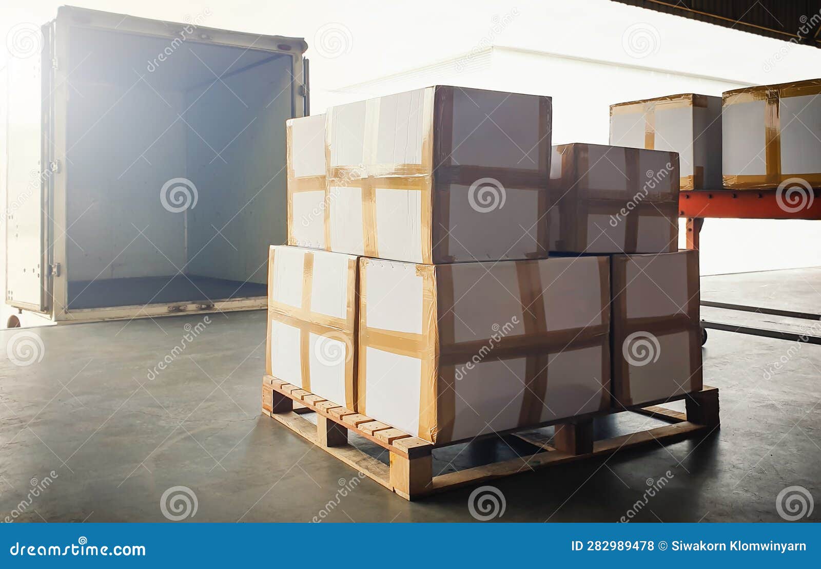 Package Boxes Stack on Pallets Loading into Cargo Trucks. Trucks ...