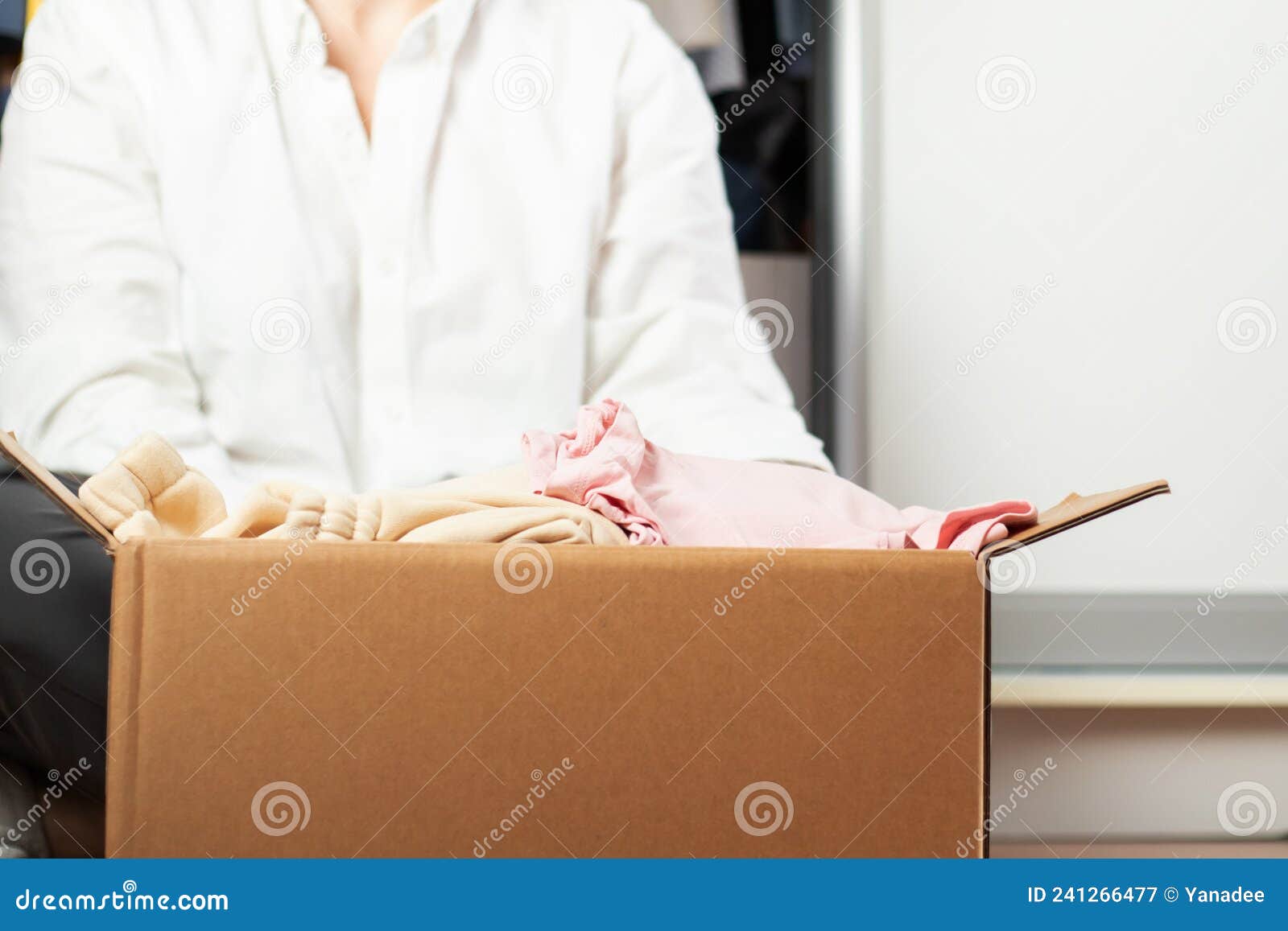 Package with Clothes, a Woman at Home Opens a Box with an Order for ...