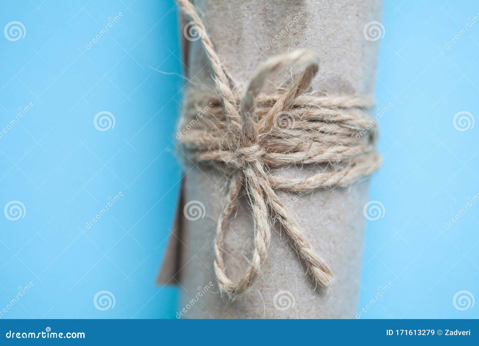 Package Roll in Craft Paper on a Blue Background Stock Image - Image of ...